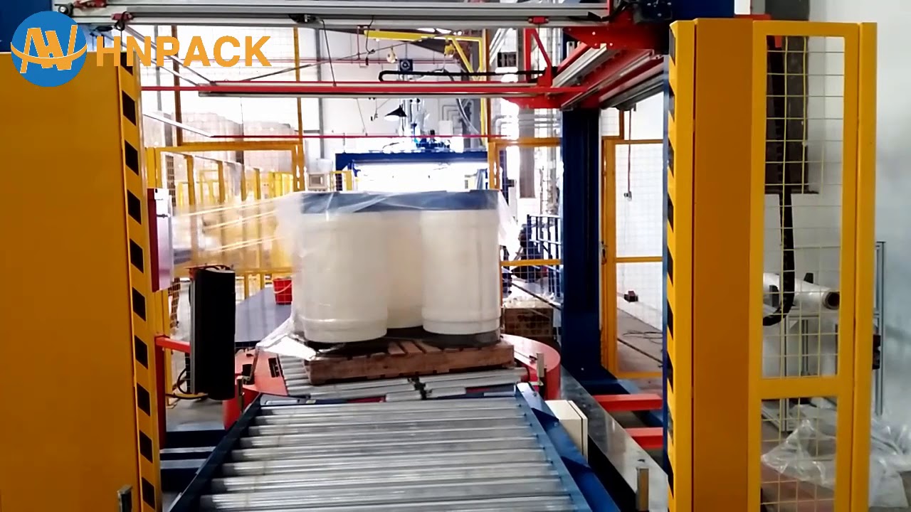 Fully automated turntable pallet wrapper with stretch top film cover ... Fully automated turntable pallet wrapper with stretch top film cover ...